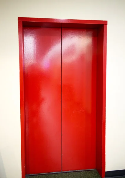 Freshly painted red elevator doors - Stock Image - Everypixel