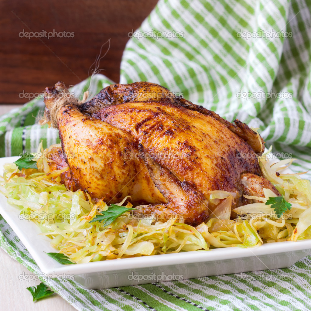 Roasted whole chicken with golden crust and garnish of stewed ca ...