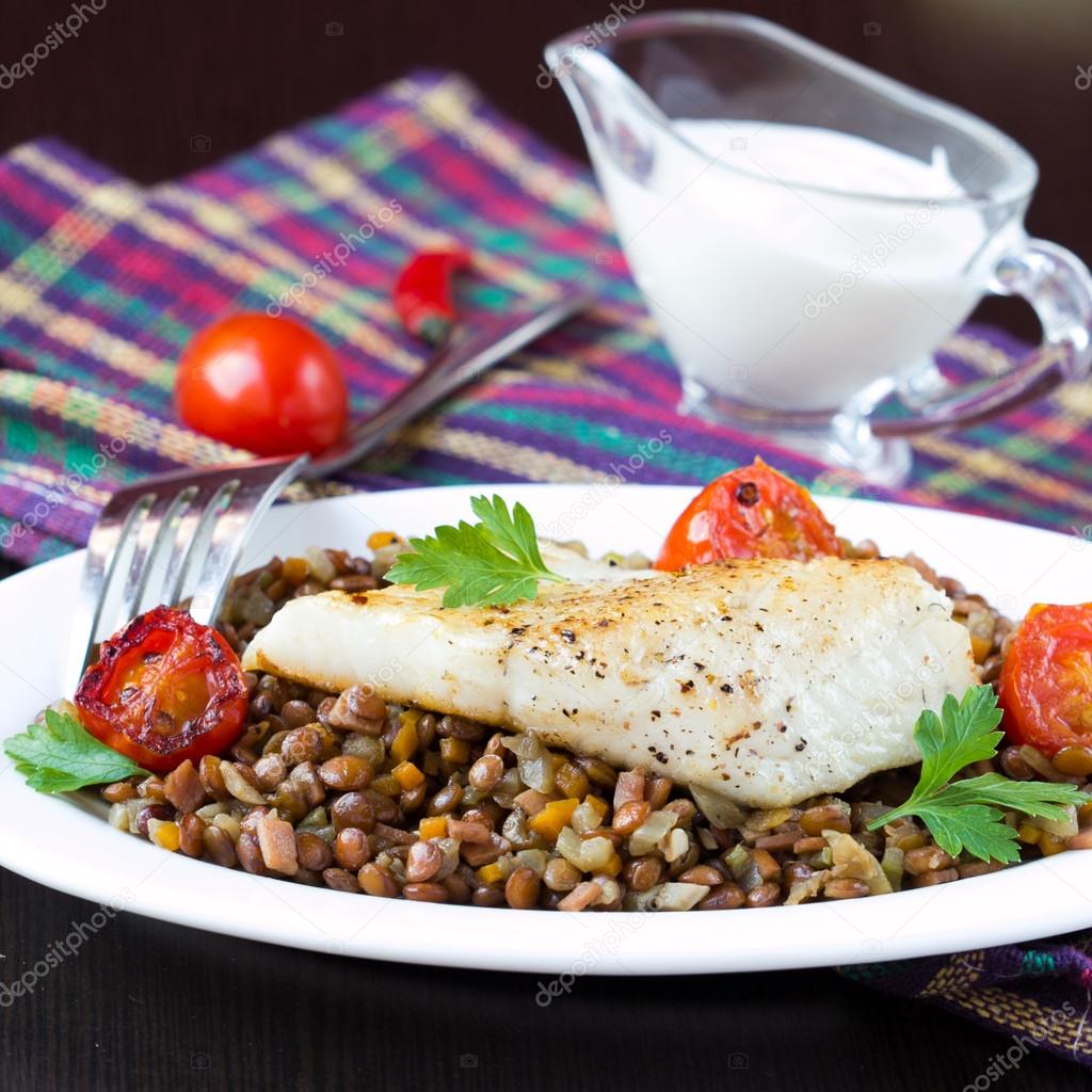 White fish fillet of perch, cod with vegetables and lentils, tom ...