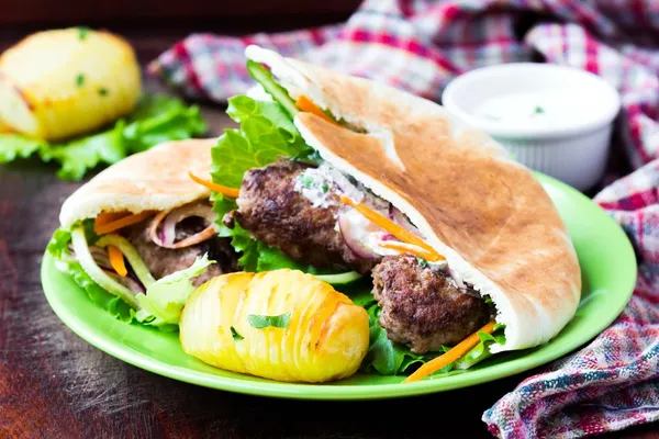 Minced meat kebab, beef balls in flat cake with vegetable Stock Photo ...