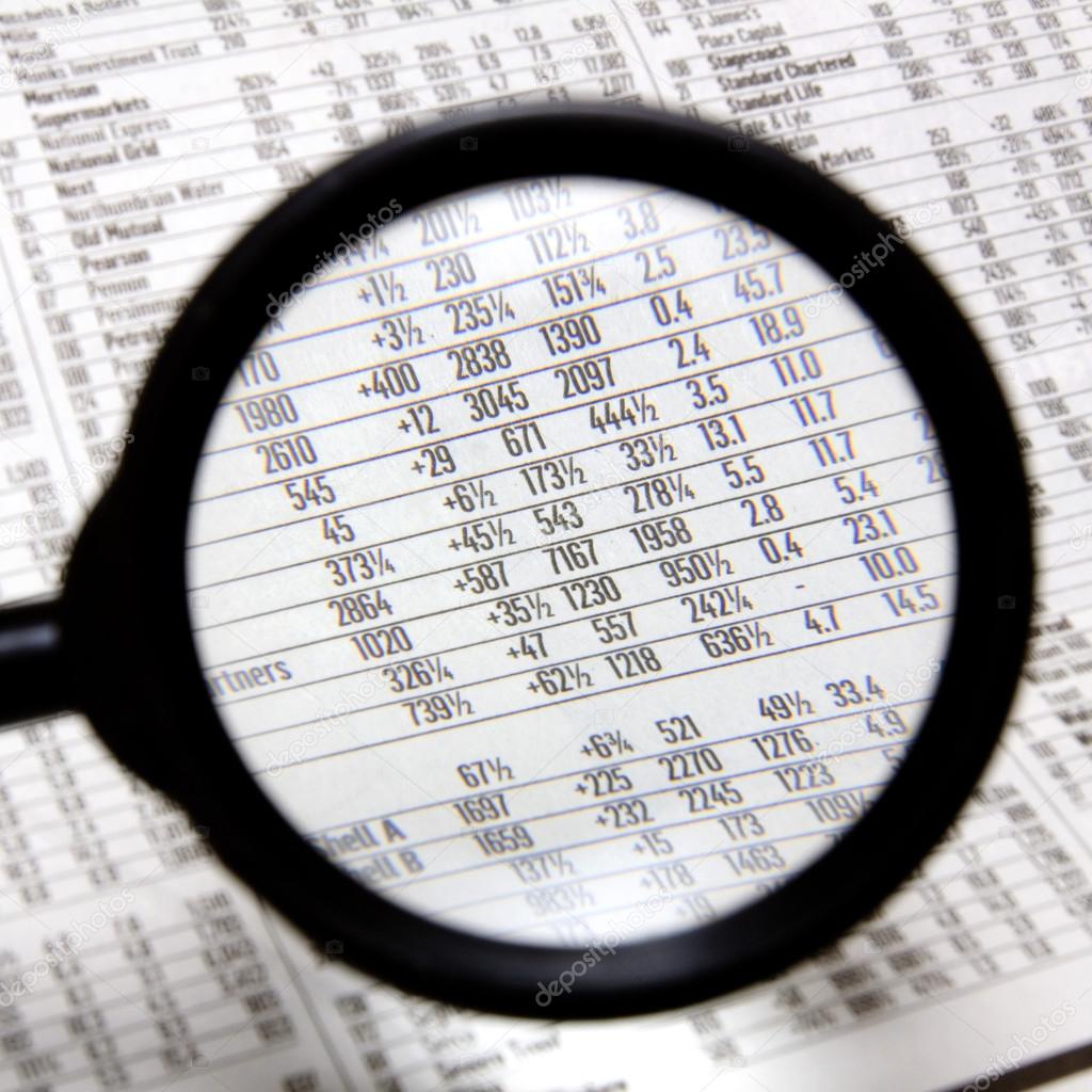 Magnifying glass over stocks and shares — Stock Photo © west1 #17202911