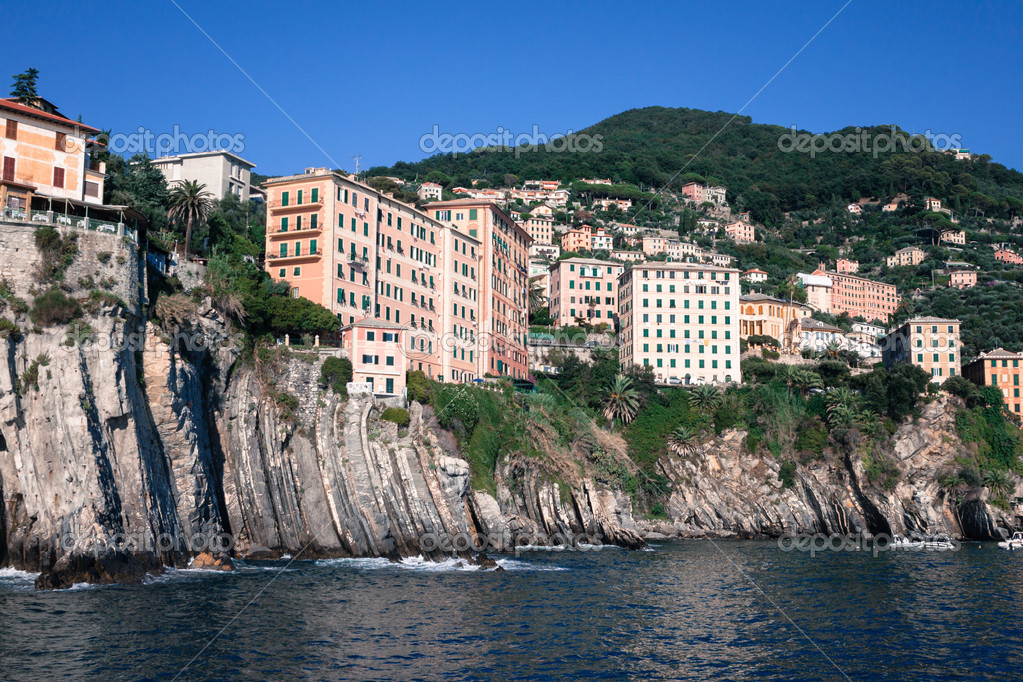 Houses built on the rocks overhanging sea — Stock Photo © tinx #30900389