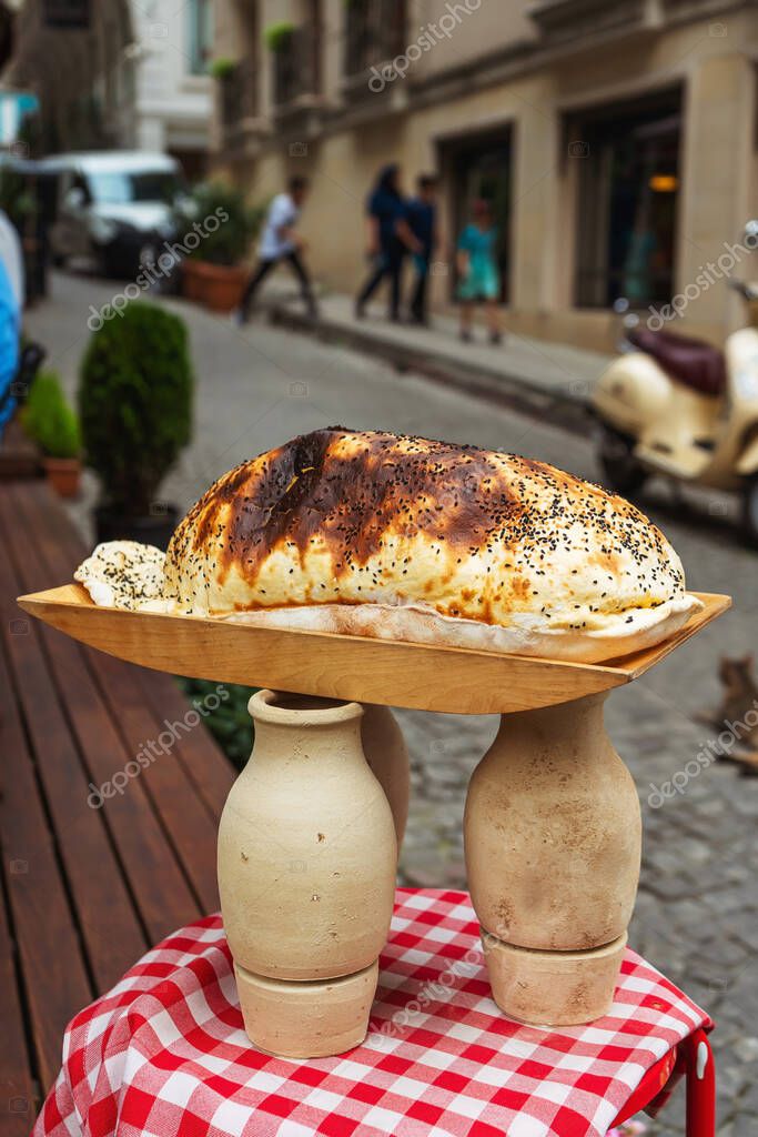 Turkish traditional bread in the form of an airy fluffy pillow on clay ...