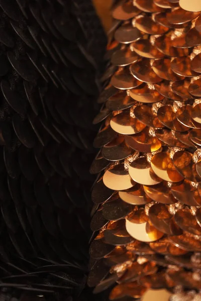 The texture of large sequins on the fabric. gold sequins sewn to the ...