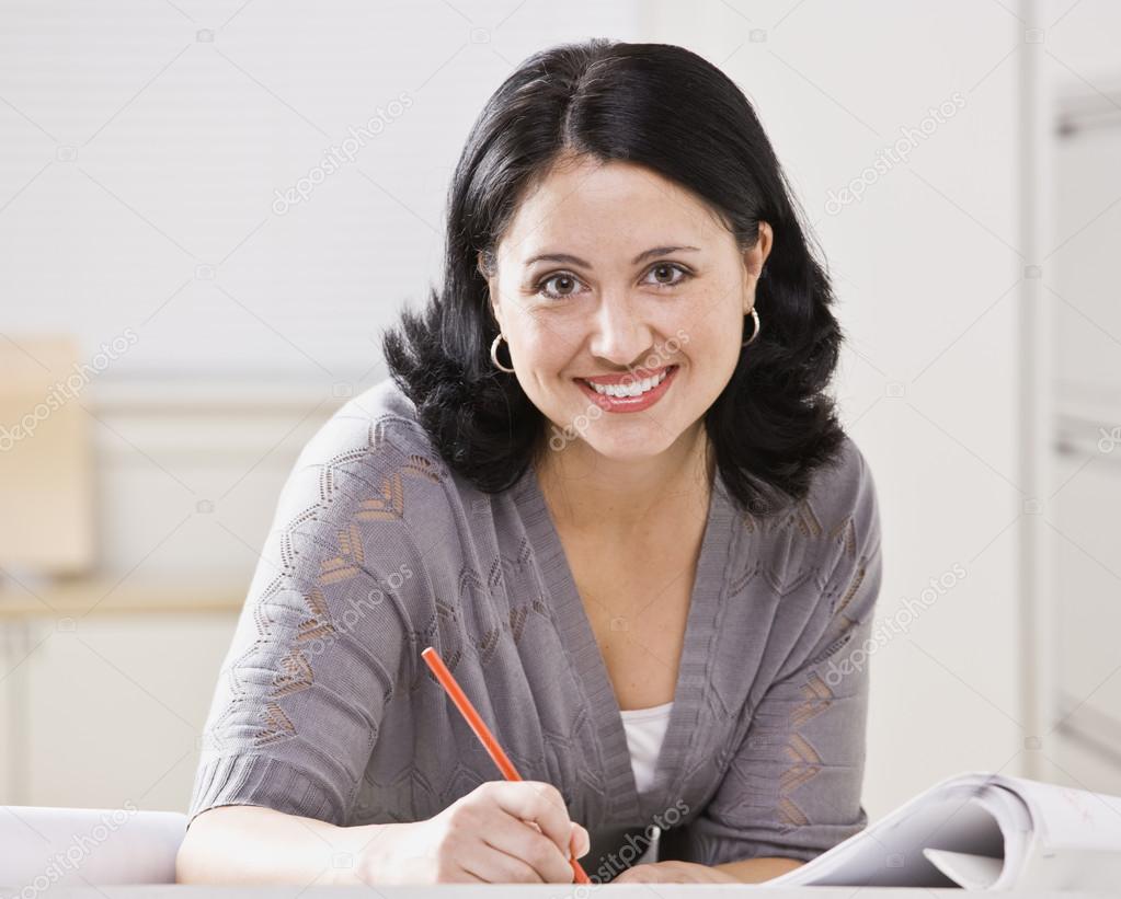 Beautiful Hispanic Woman Writing — Stock Photo © Spaces #18772165