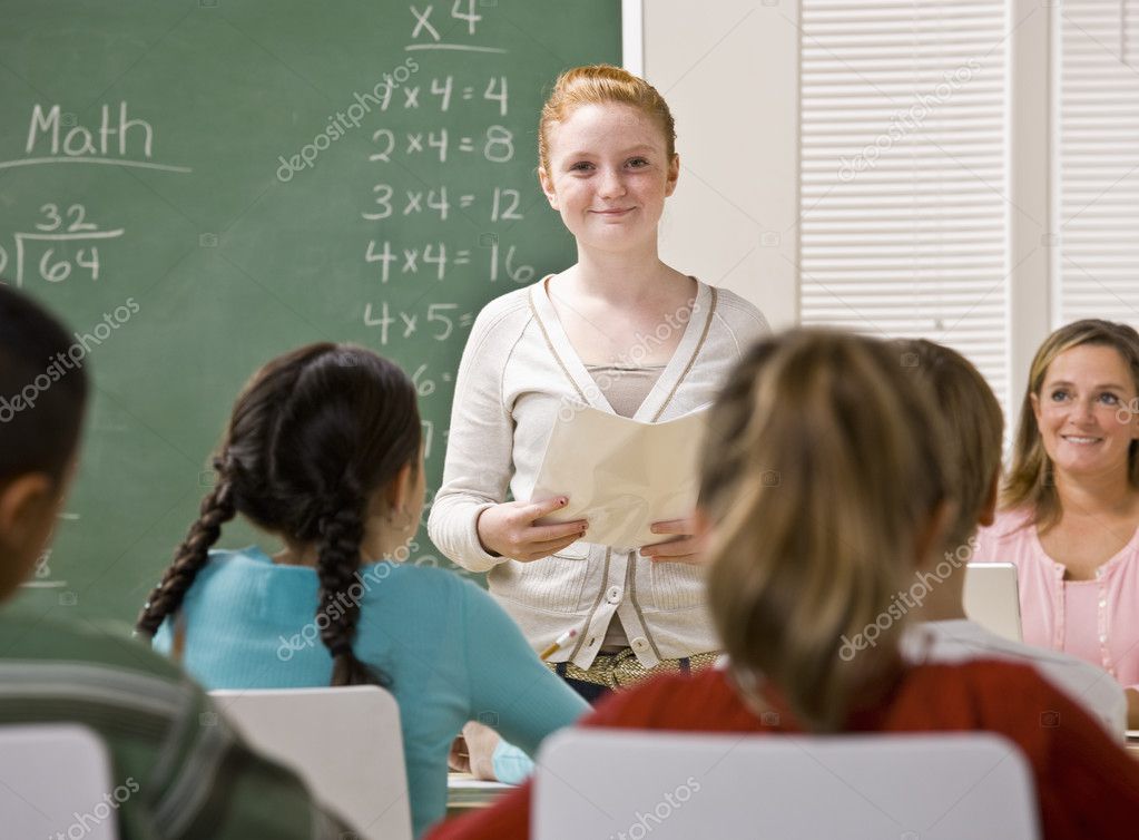 Student giving report in classroom Stock Photo by ©Spaces 18784845