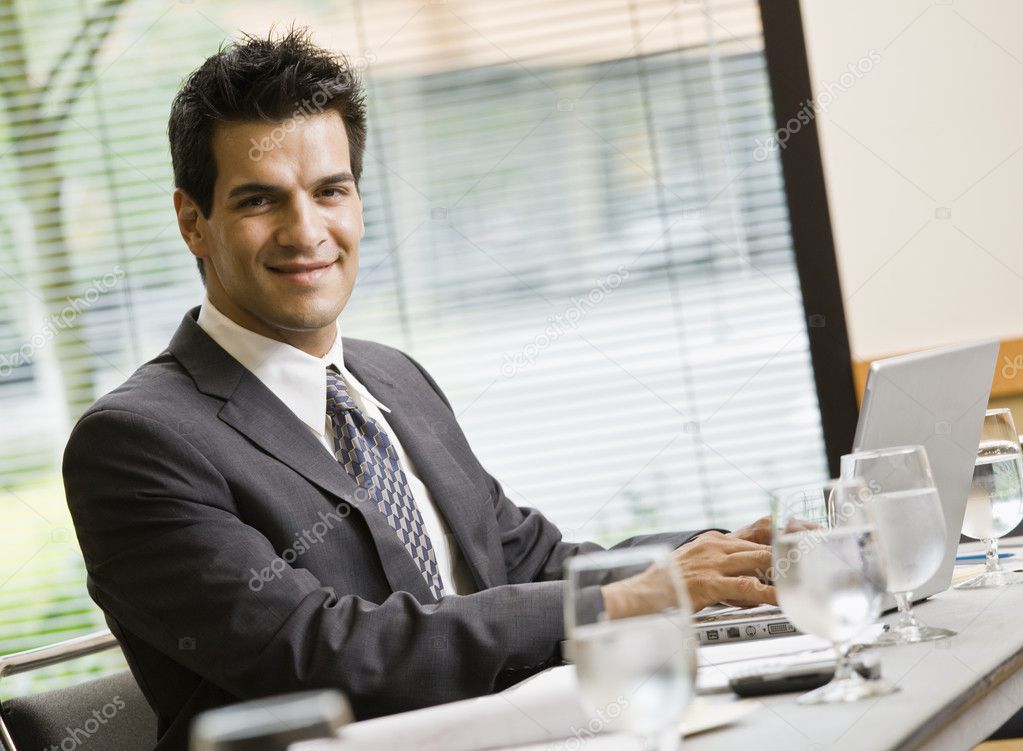 Man in Business Suit Smiling with laptop Stock Photo by ©Spaces 18800499