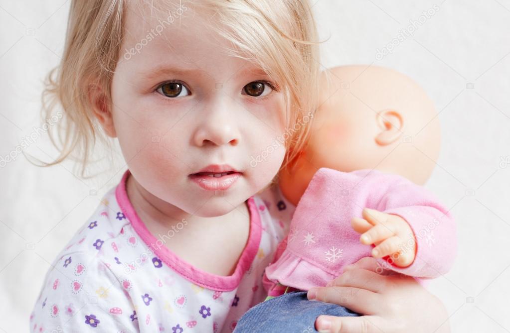 Cute little girl with a doll Stock Photo by ©marchibas 26379491