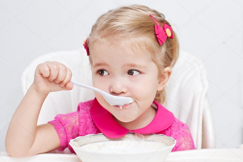 Cute little girl eats Stock Photo by ©marchibas 36241051