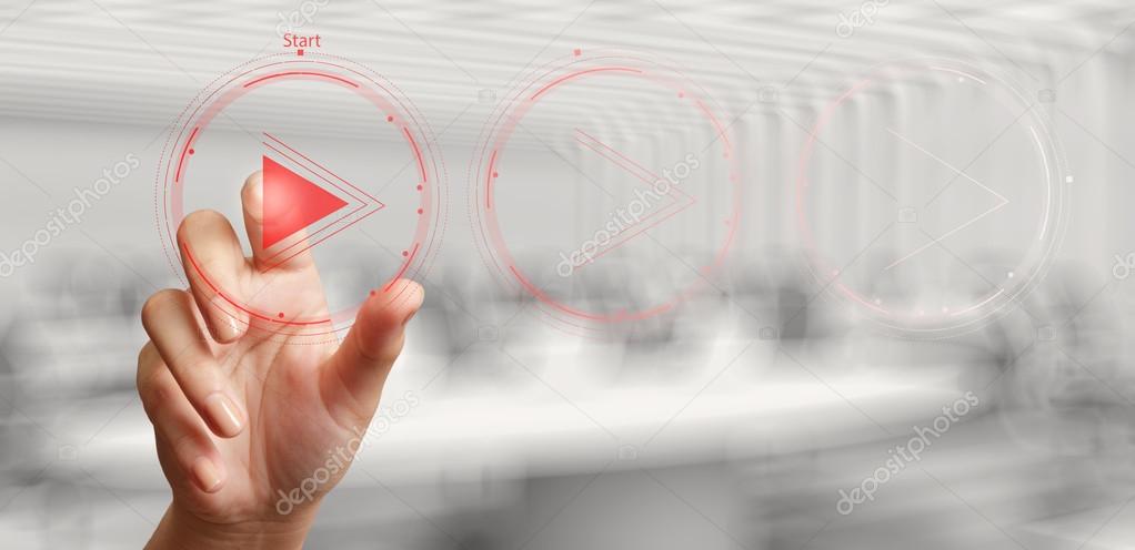 Hand press play button sign to start or initiate projects as con ...