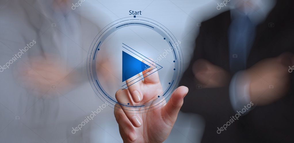 Hand press play button sign to start or initiate projects as con ...