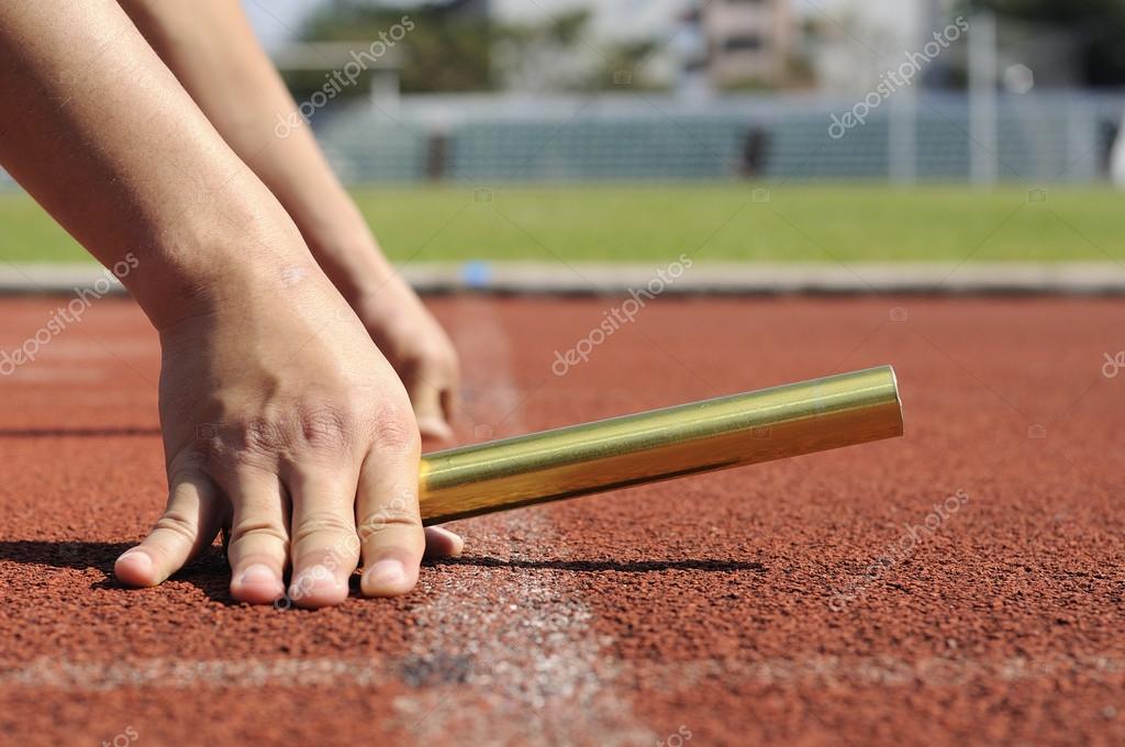 Relay-athletes hands starting action. — Stock Photo © ekarina #40169285
