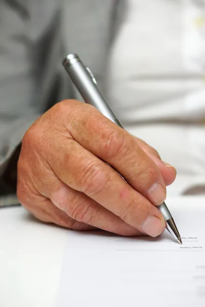 Older woman signing the document — Stock Photo © bacho123456 #43352097