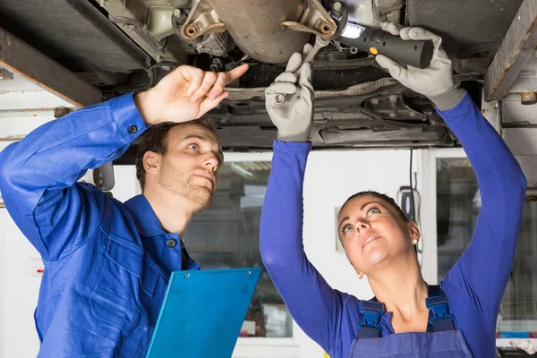 Two mechanics taking a look under the hood of a car — Stock Photo ...