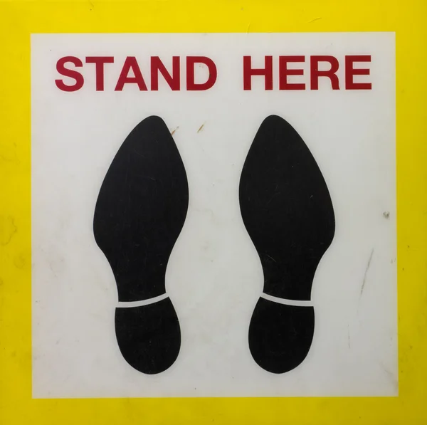 PLEASE STAND HERE foot sign — Stock Photo © PhanuwatNandee #66584933