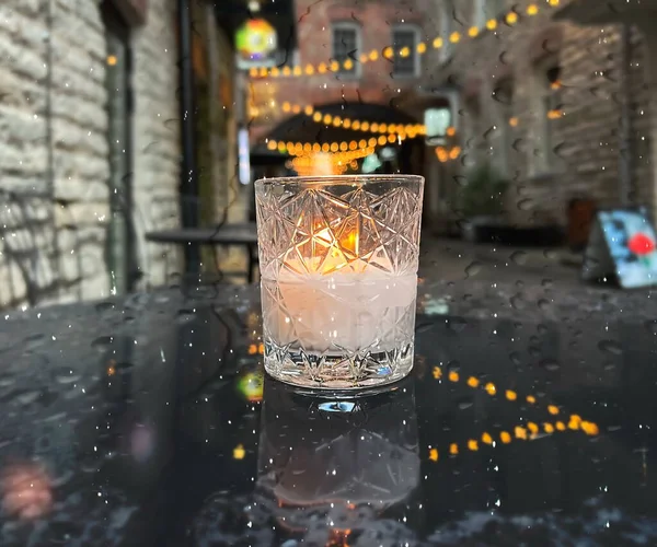 candle light on street cafe table in evening rainy city blurred bokeh ...
