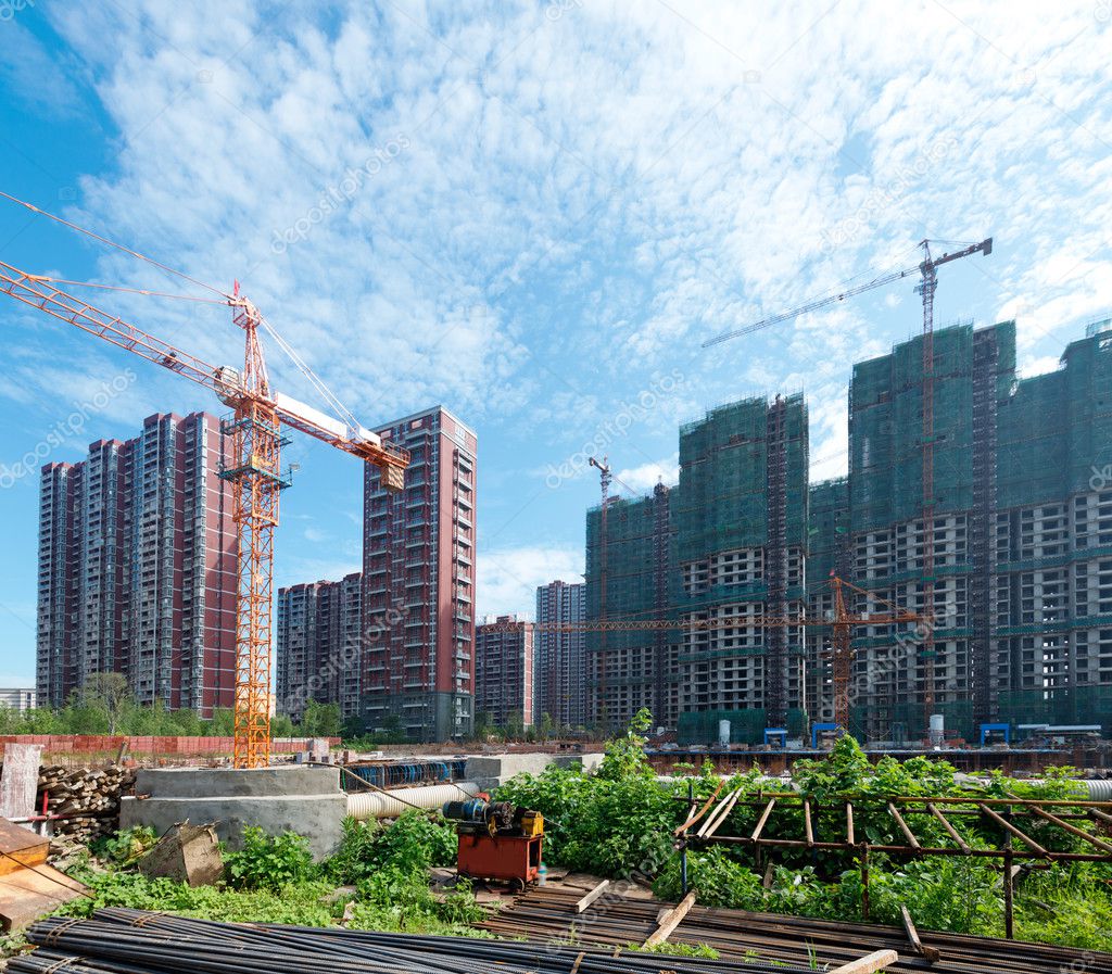 Multiple cranes working on huge construction site Stock Photo by ...