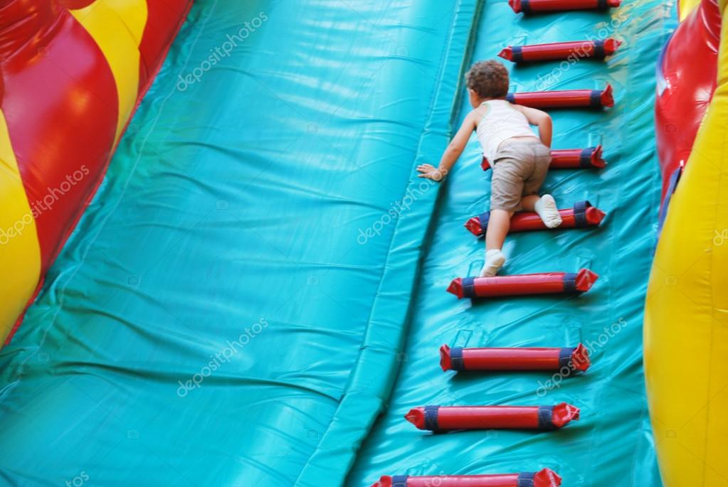 Little boy playing on an inflatable playground — Stock Photo ...