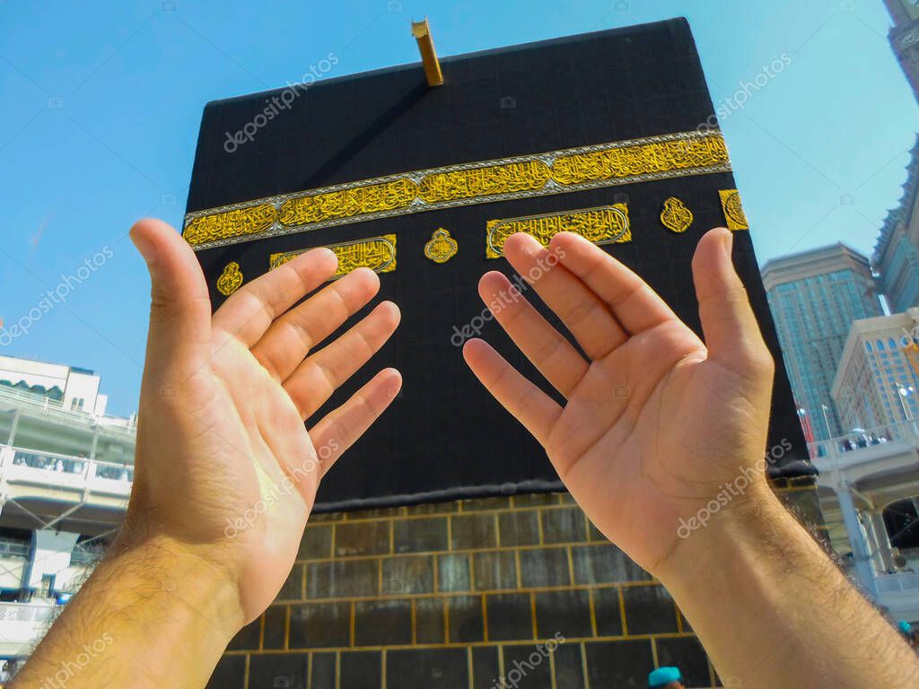 Musulmanes rezando con las manos abiertas en el lugar santo Kaaba 2025