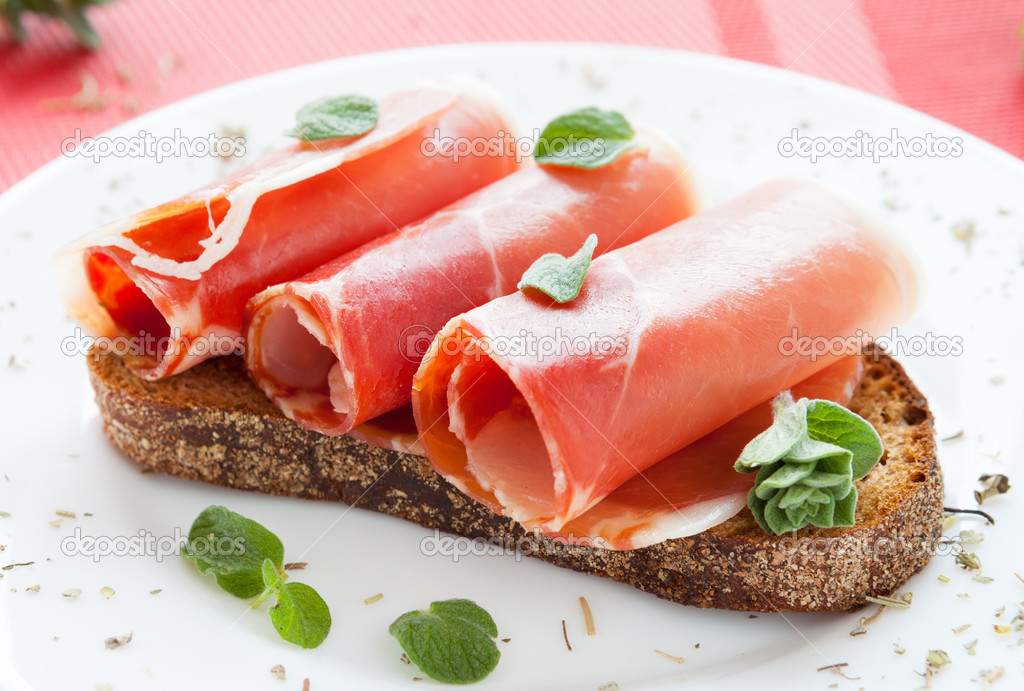 Spanish jamon slices on a piece of corn bread Stock Photo by ...