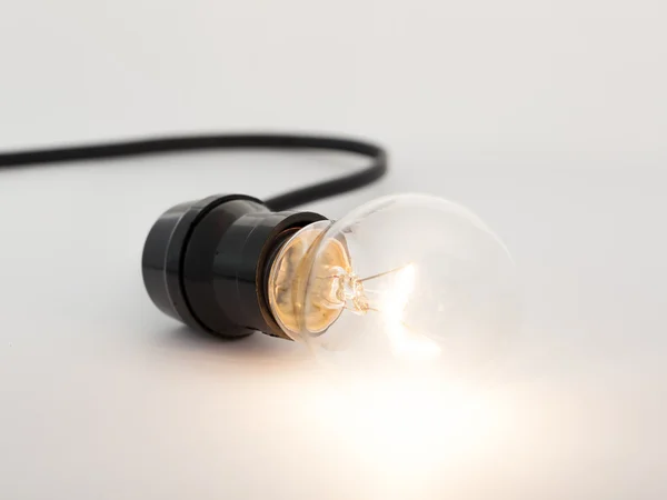 Light bulb and a plug with a cord Stock Photo by ©jannystockphoto 66080341