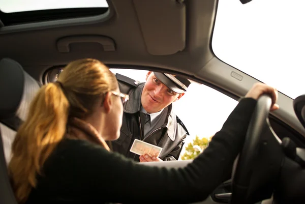 Police officer checking driving license - Stock Image - Everypixel