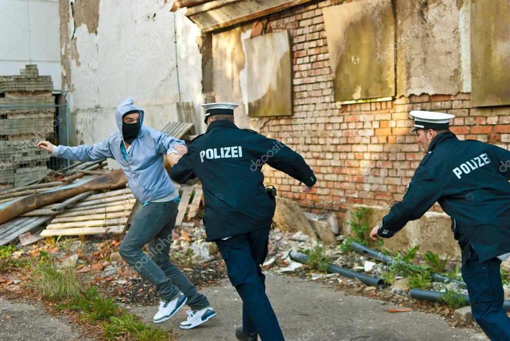 Police officers are chasing man — Stock Photo © mattomedia #19022537