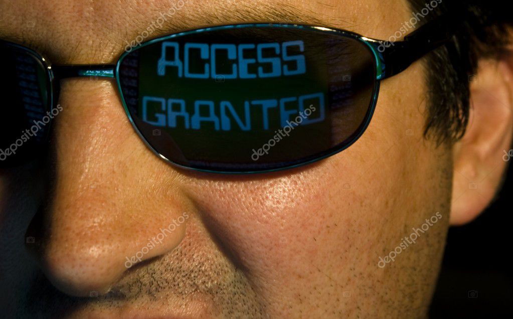 A computer hacker smiles as he successfully hacks in — Stock Photo ...