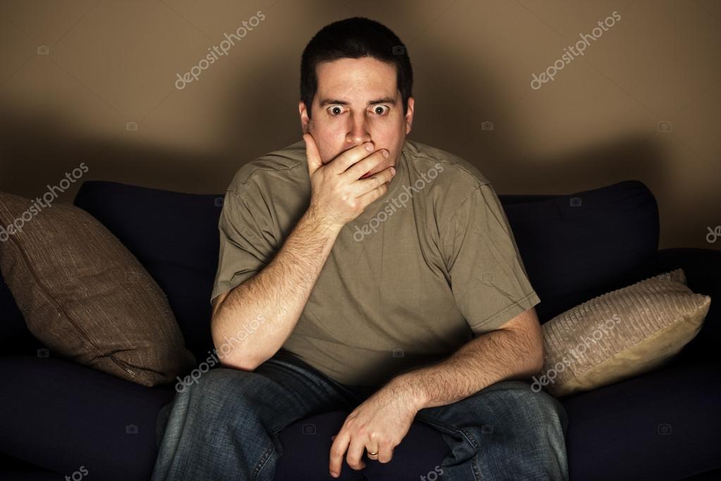 Man shocked by what he sees on the television — Stock Photo © dcdp ...