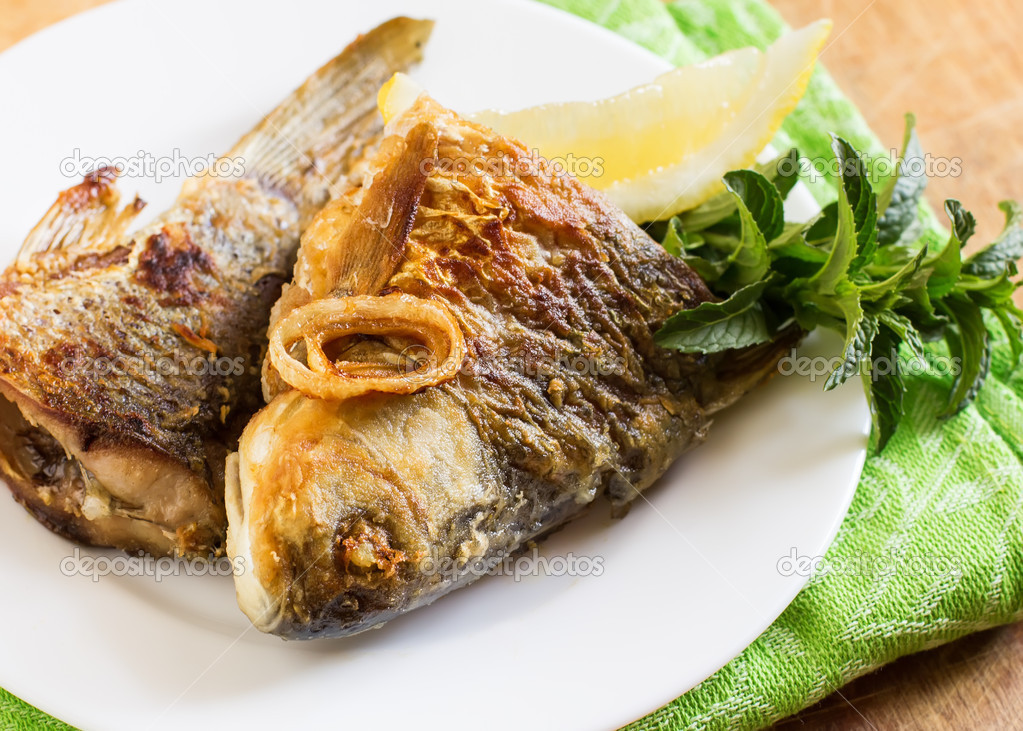 Fried fish on plate — Stock Photo © daffodil #25642135