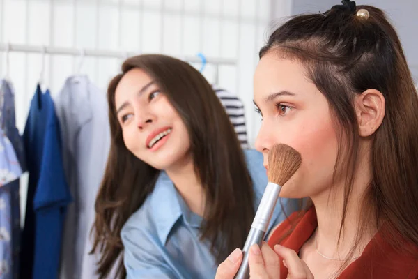 Professional make up artist using a dry powder cosmetic applying on ...