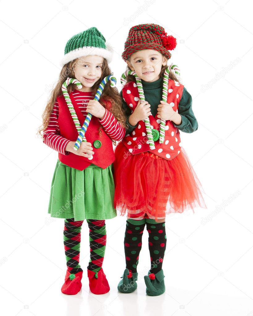 Two lIttle christmas elves hold candy canes and suckers — Stock Photo ...
