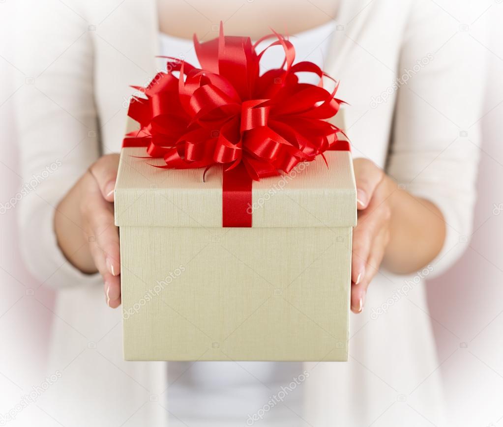 Hands holding beautiful gift box Stock Photo by ©lateci 34357431