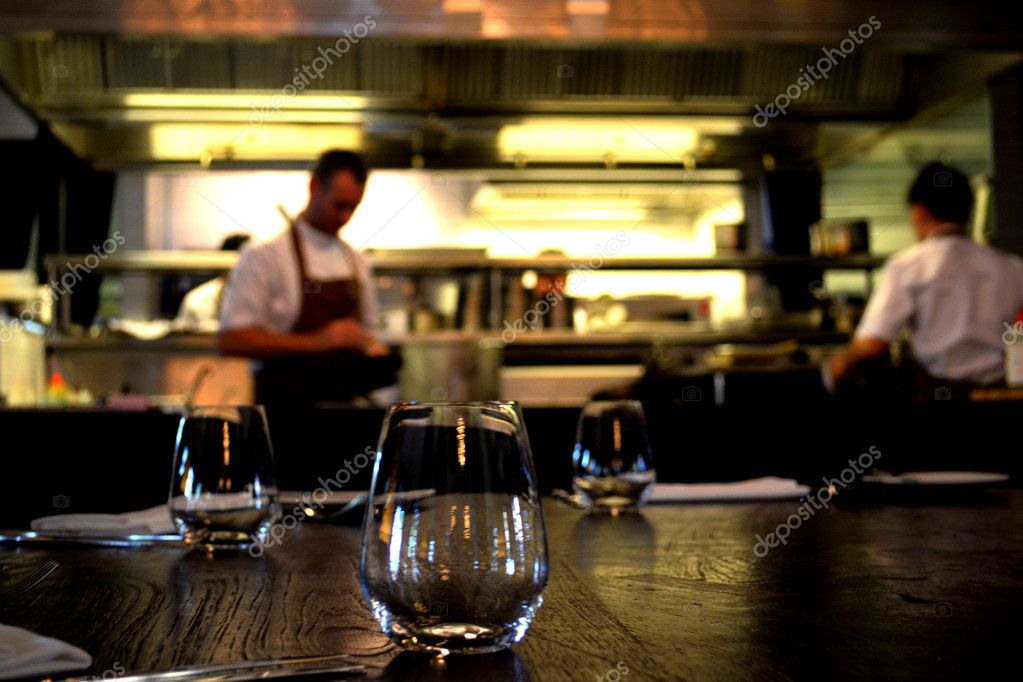 Chef in open kitchen in casual dining restaurant Stock Photo by ...
