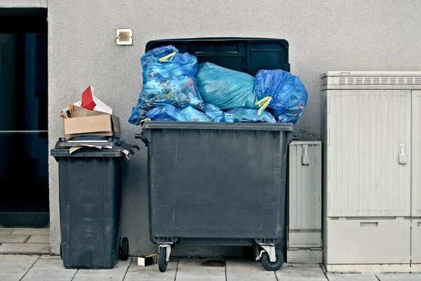 Dirty public trash cans on the pavement. - Stock Image - Everypixel