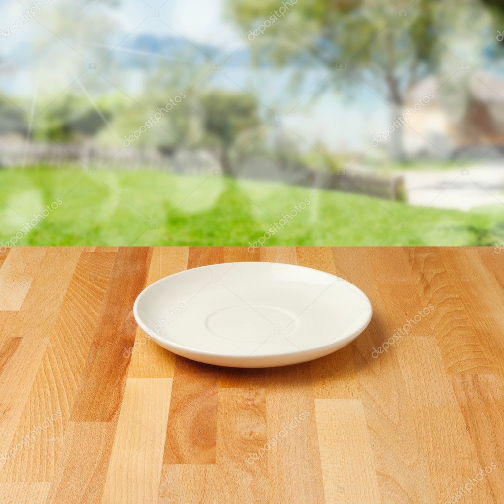 Empty plate on wooden table over nature background — Stock Photo ...