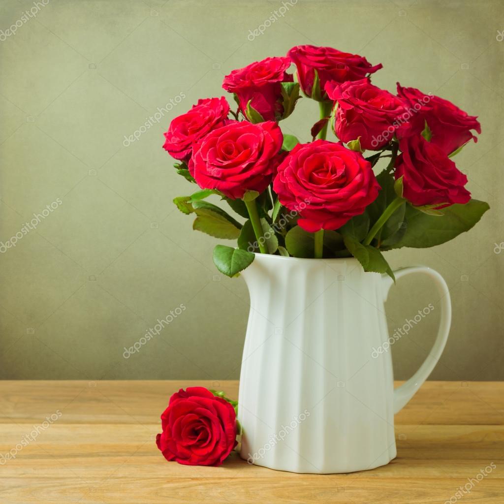 Rose flower bouquet in jug on wooden table Stock Photo by ©maglara 29640803