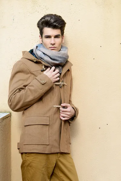 Attractive young handsome man, model of fashion in urban backgro ...