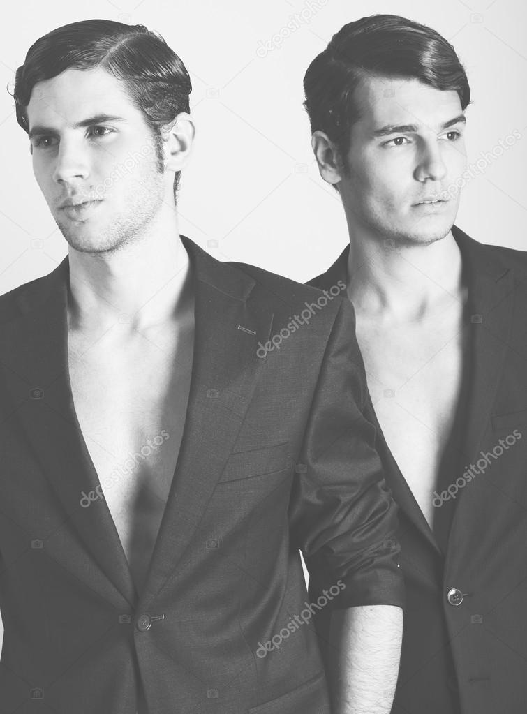 Two young attractive men wearing suit Stock Photo by ©javiindy 24772757