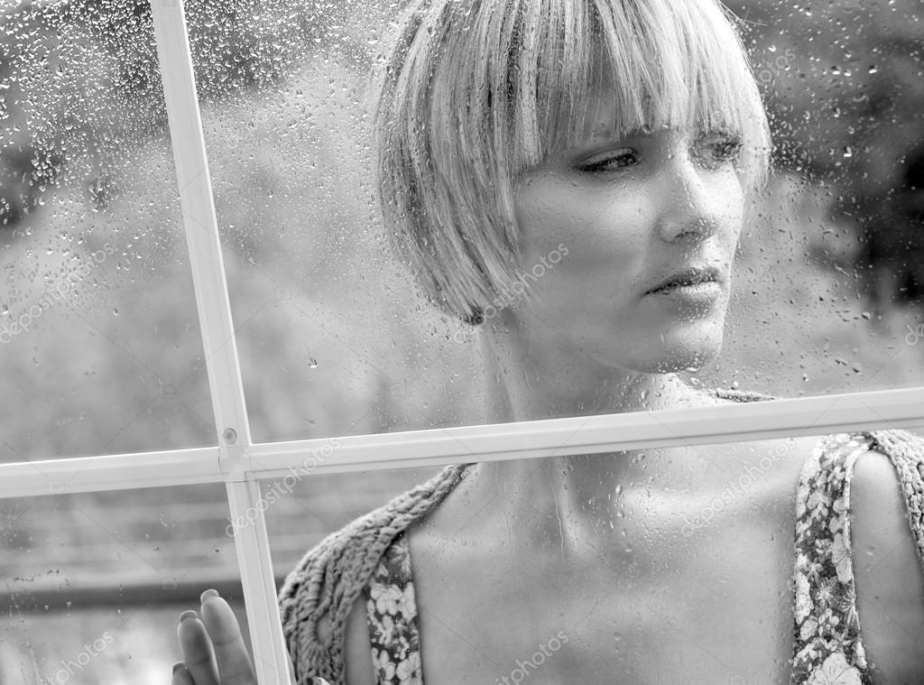 Sad woman at the window Stock Photo by ©bertys30 26580485