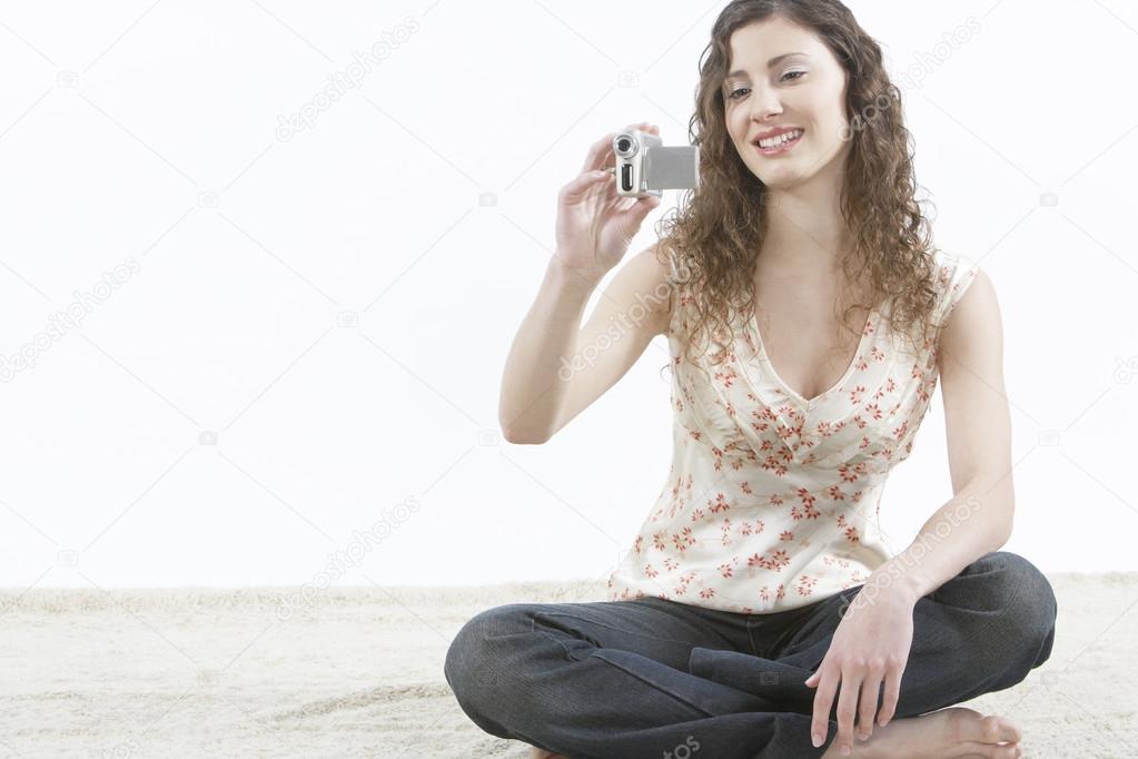 Woman filming with a small digital video camera — Stock Photo © mjth ...