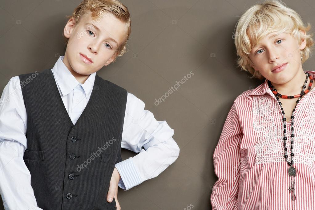Two young brothers standing together showing attitude and different ...