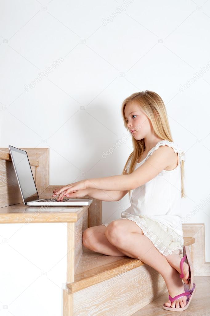 Girl using a laptop computer Stock Photo by ©mjth 47842749