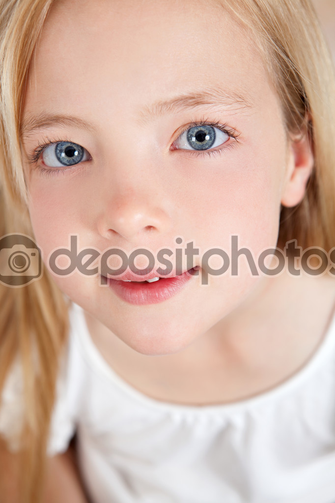 Girl looking innocent and smiling at the camera. — Stock Photo © mjth #47842823