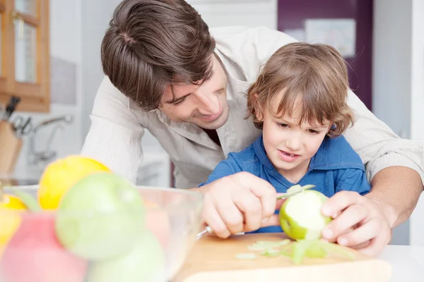 Dad with his son together in a home kitchen - Stock Image - Everypixel