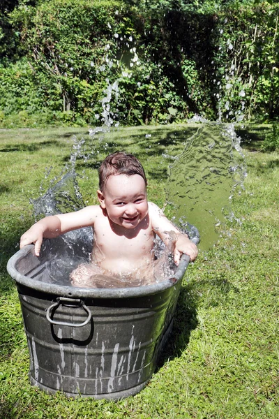 Twin brothers playing with bucket of water in bath — Stock Photo ...