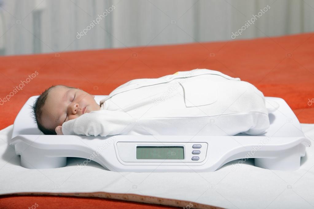 Baby on weight scale — Stock Photo © benedamiroslav #20564959