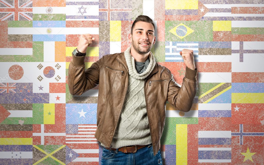 Young man winner over background with flags — Stock Photo ...