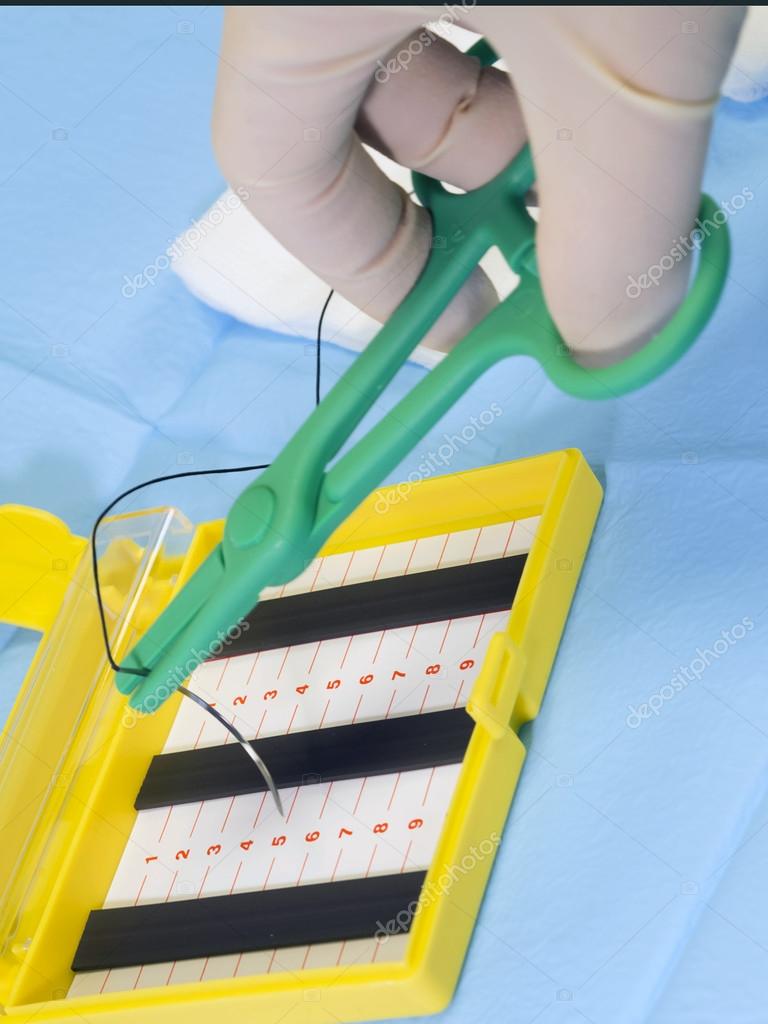 Suture needle resting on needle holder Stock Photo by ©starman963 32802269