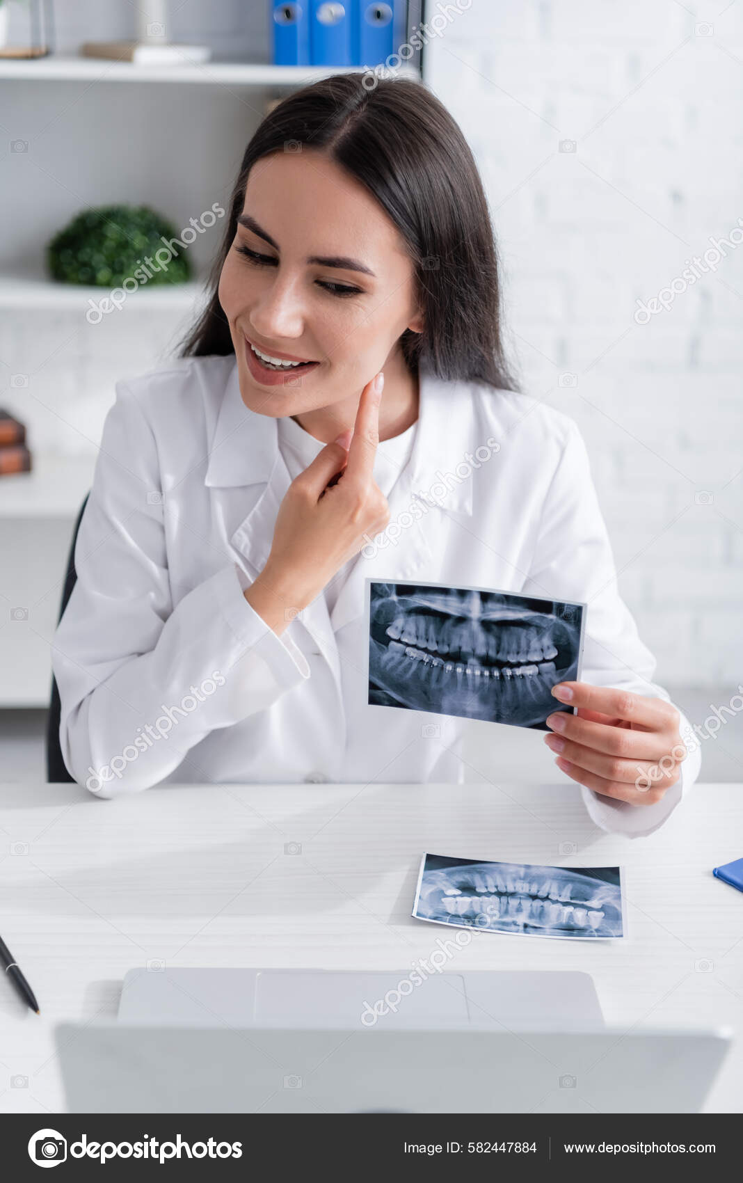 Positive Doctor Holding Scan Teeth Pointing Cheek Video Call Laptop ...